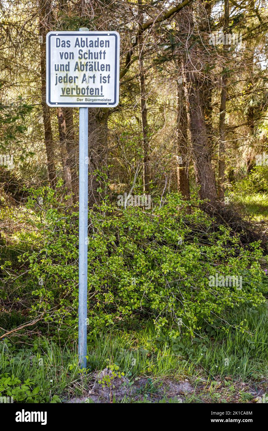 Prohibition sign on the forest path: The unloading of rubble and waste ...