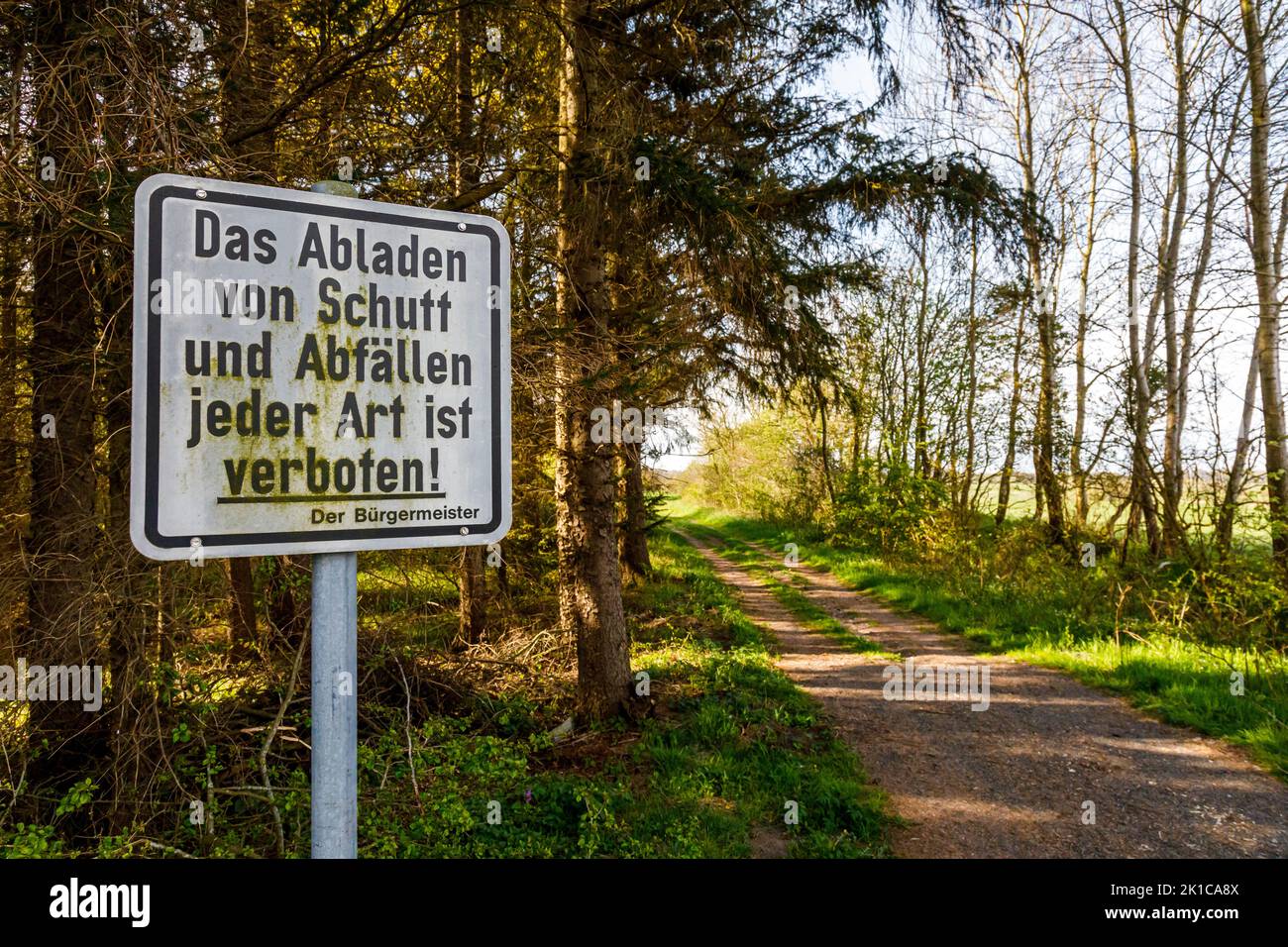 Prohibition sign on the forest path: The unloading of rubble and waste ...
