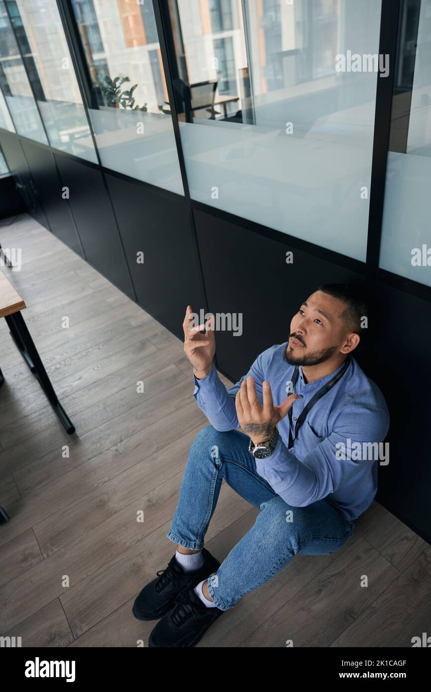 Corporate worker asking for help from above Stock Photo - Alamy