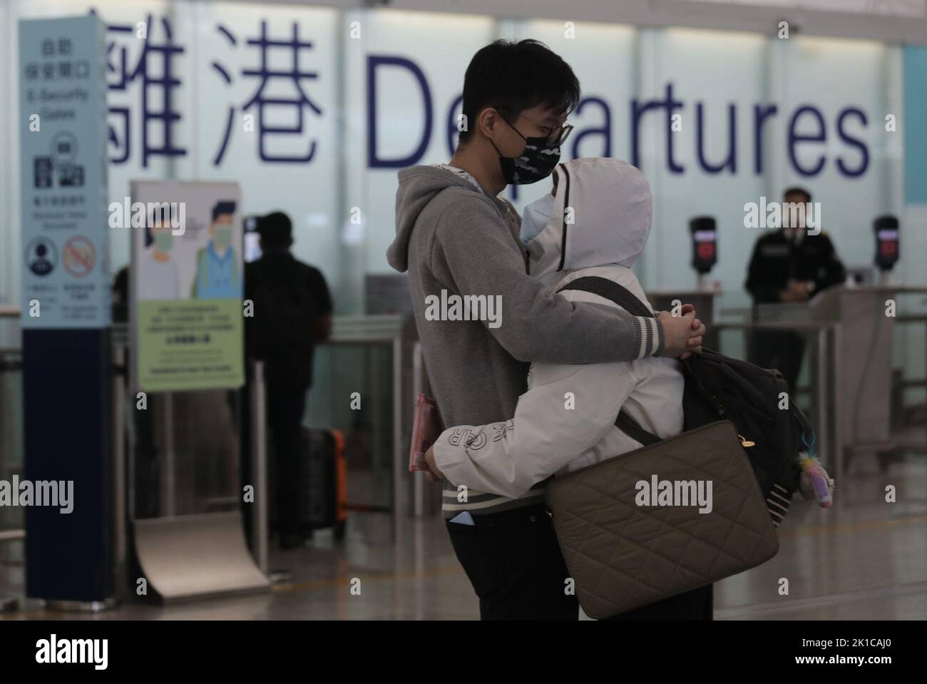 A couple say goodbye to each other at Hong Kong International Airport, Chek Lap Kok. 03APR22 ...
