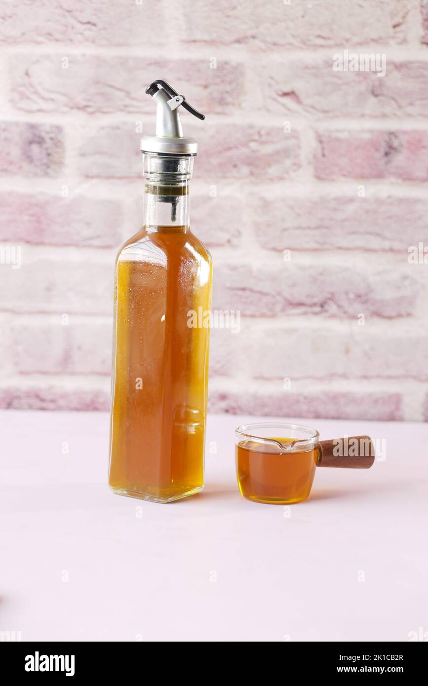 Mustard oil in a plastic jar on table Stock Photo - Alamy