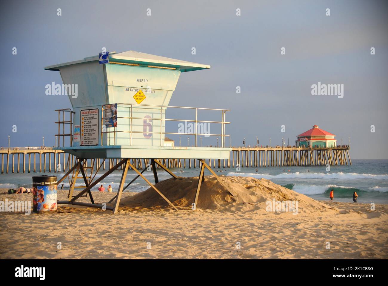 A lifeguard tower on a californian beach at sunset. Far behind is ...