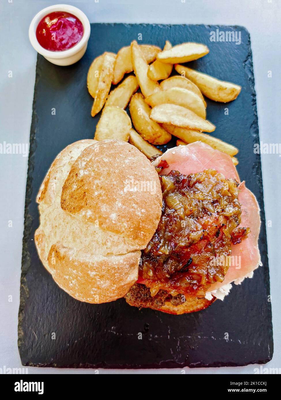 aerial view of a beef burger, cheese, bacon and tomato on a terrace on ...