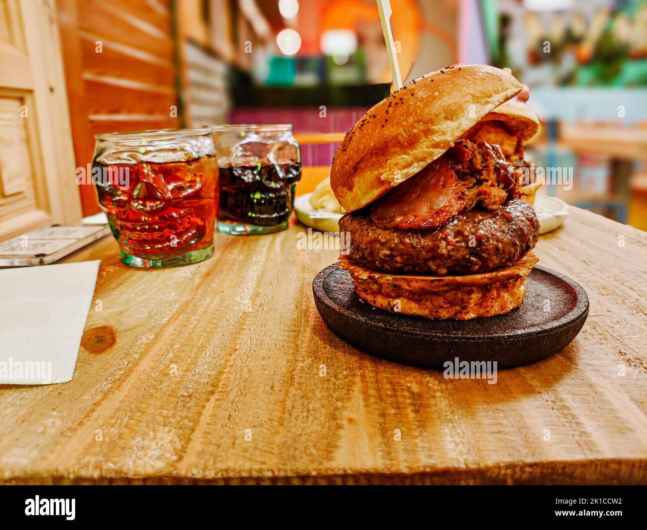 beef burger as a tall tower with skull glasses for drinks Stock Photo ...