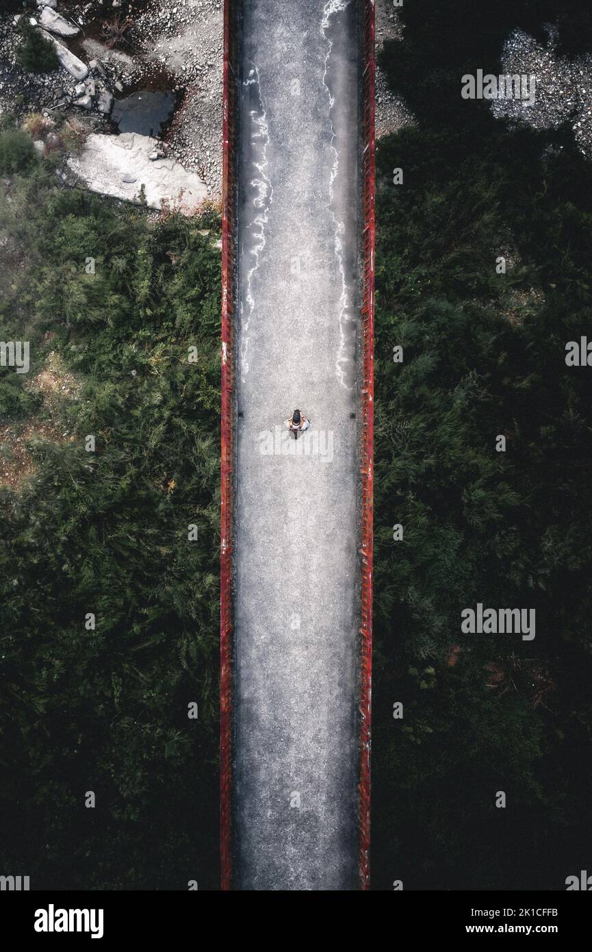 An aerial of a person crossing a bridge Stock Photo - Alamy
