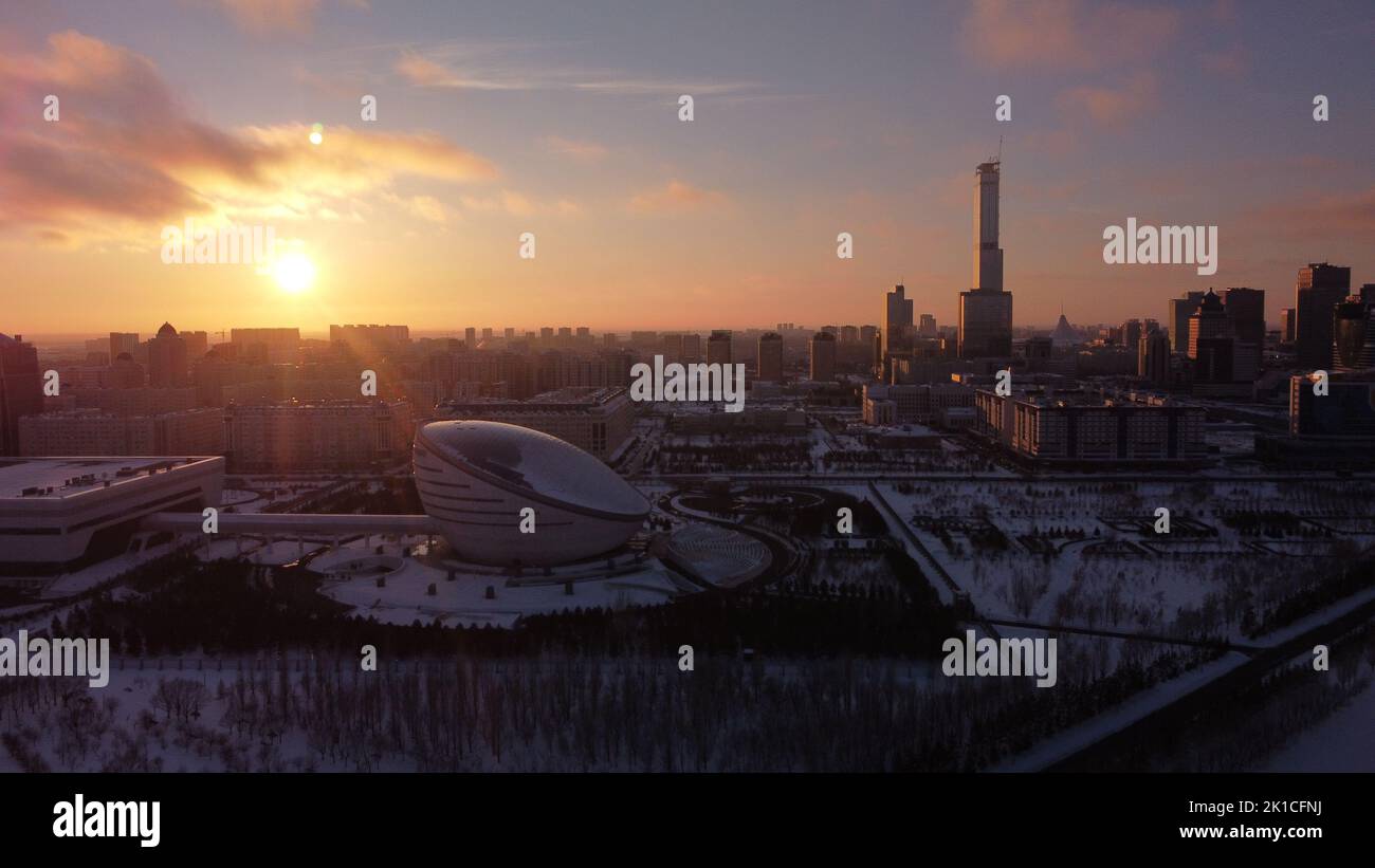 The aerial view of Nur-Sultan City landmarks under the sunset sky on ...