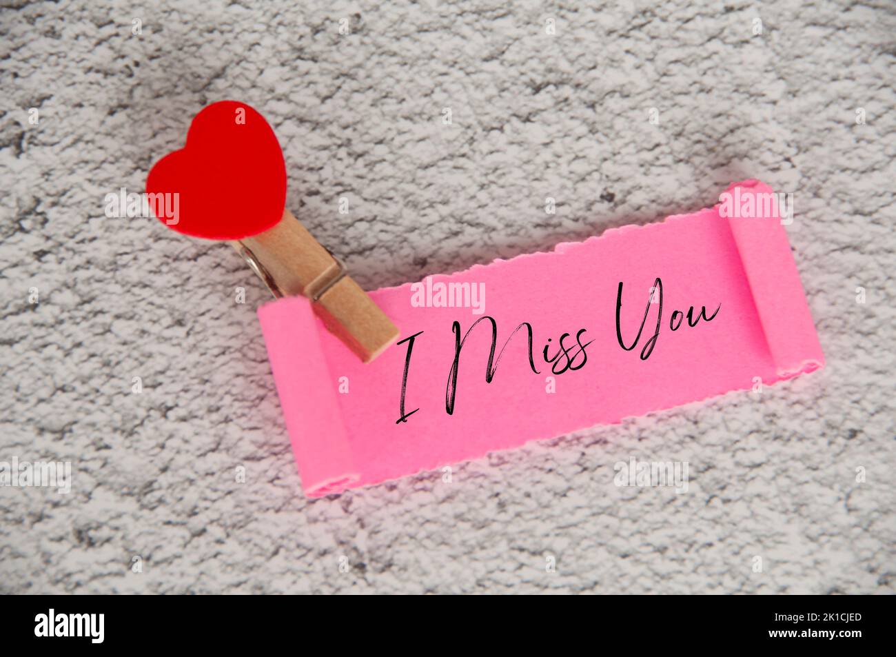 I miss you text on torn pink paper. Romance and relationship concept ...