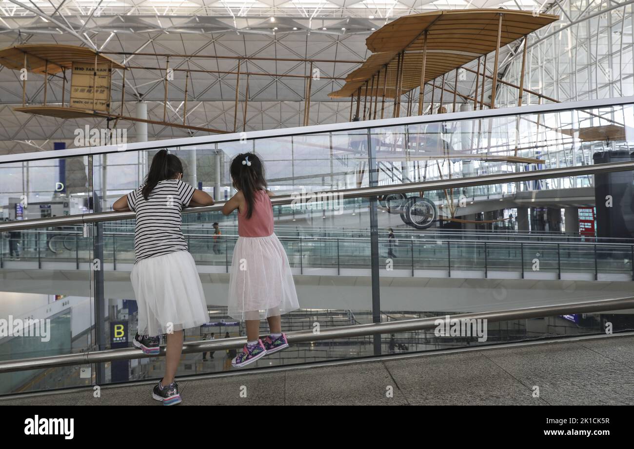 Girls looking on an eplica airplane model 'Spirit of Sha Tin' at Hong ...