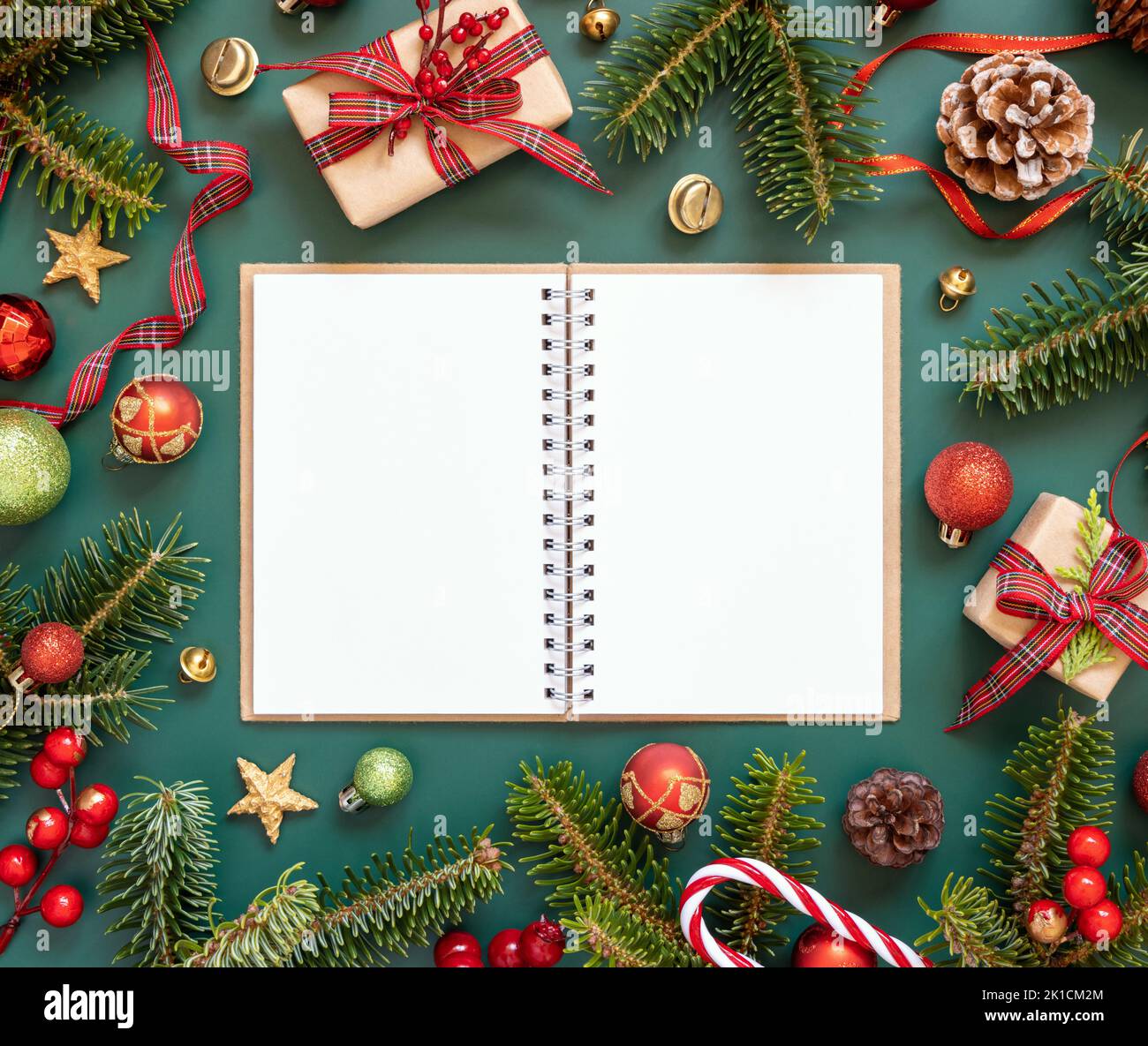 Blank open notepad on a green background near red, golden and green ...