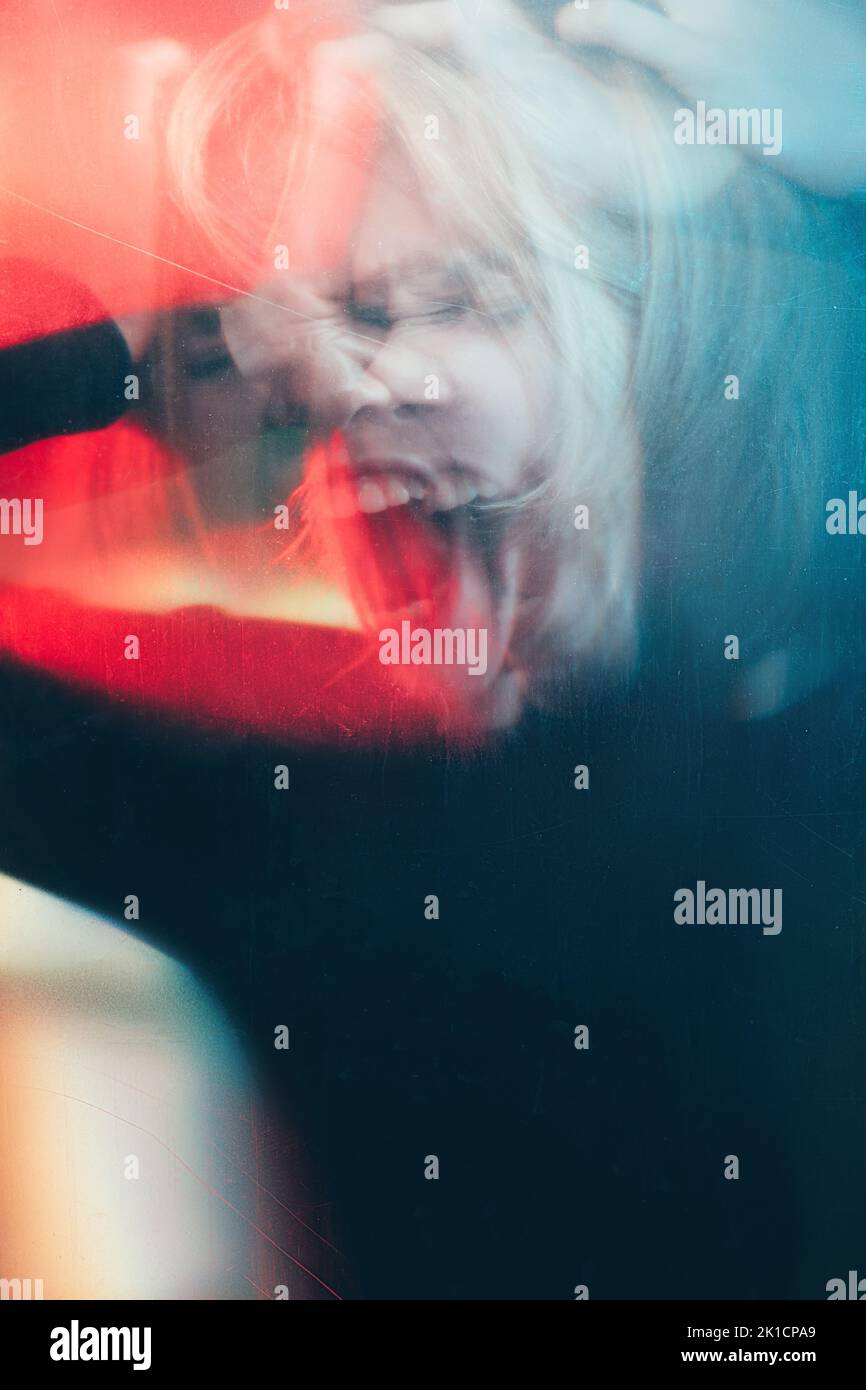 Mental disorder. Panic attack. Defocused silhouette of pissed off psycho woman with headache ...