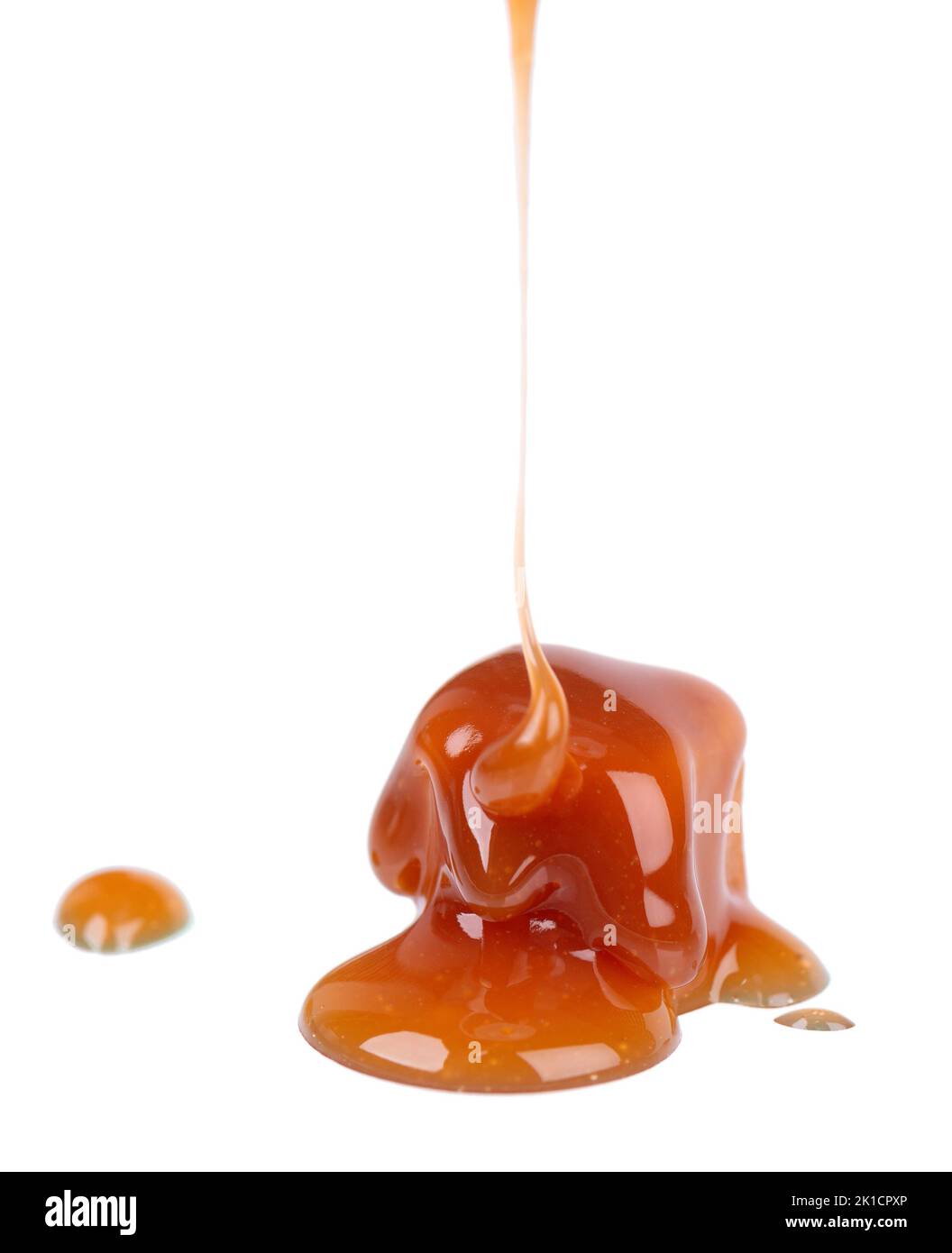 Sweet caramel candies and sauce, isolated on white background ...