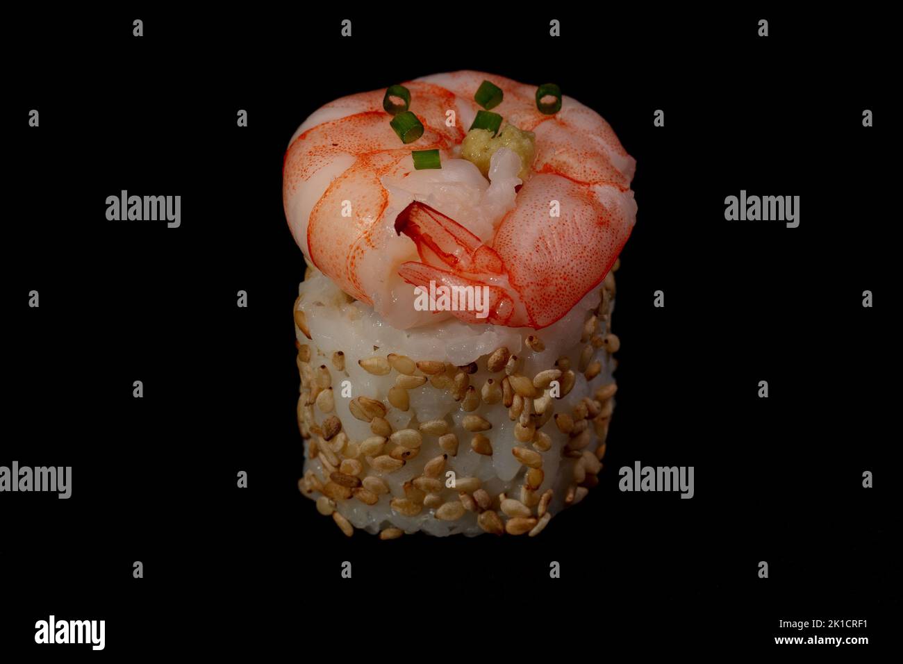 California roll with a sesame seed coating, topped with a prawn and a ...