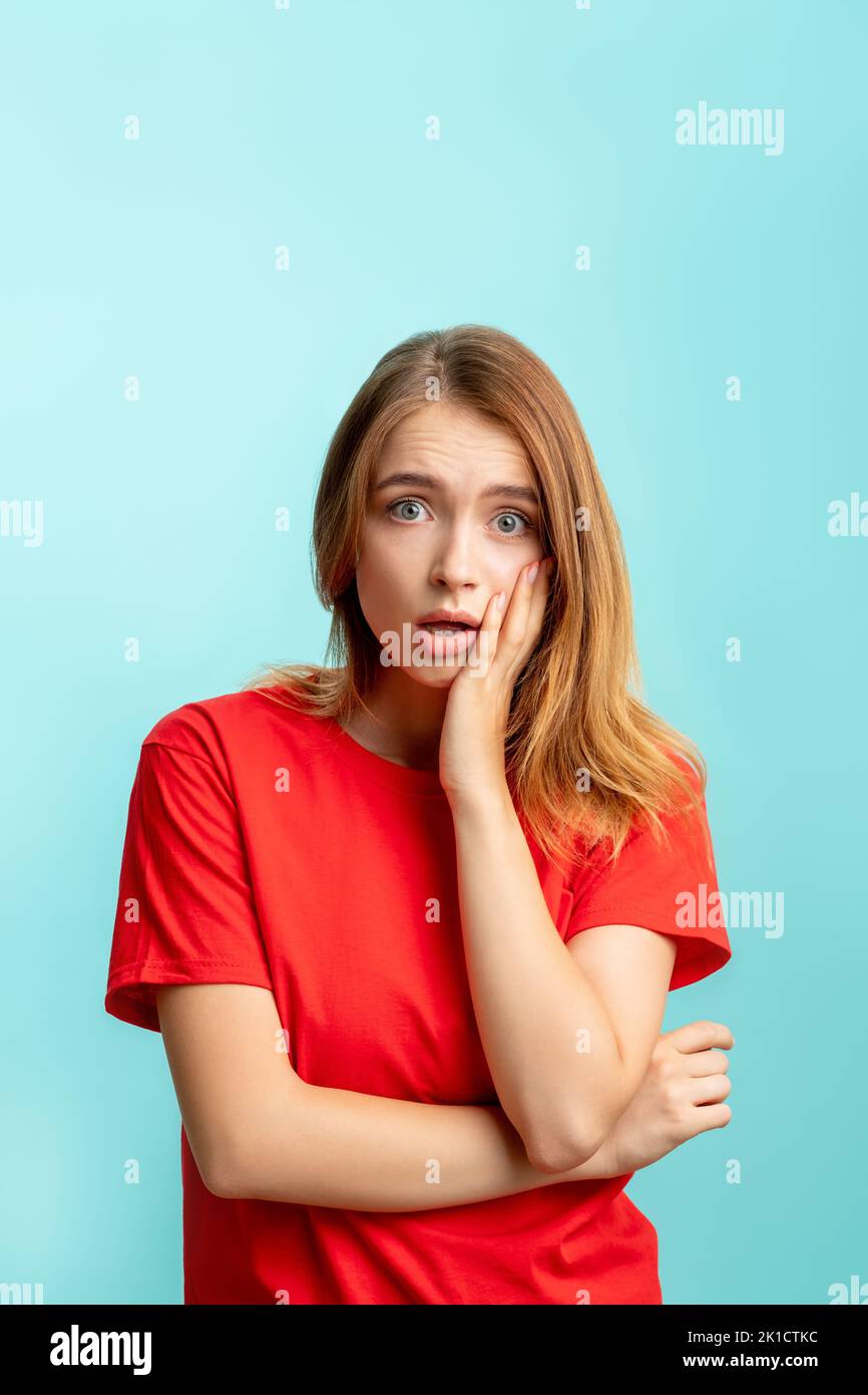 Shocked woman portrait. Omg reaction. Worried lady in red with hand on ...