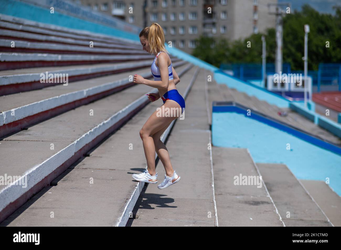 Young caucasian woman running on stadium stairs outdoors Stock Photo ...