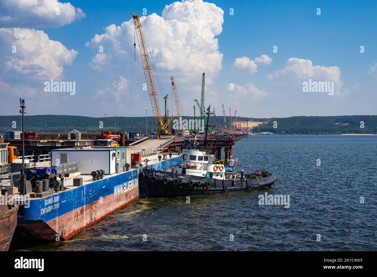 Tatarstan, Russia. August 26, 2022. The tug is moored around the barge ...