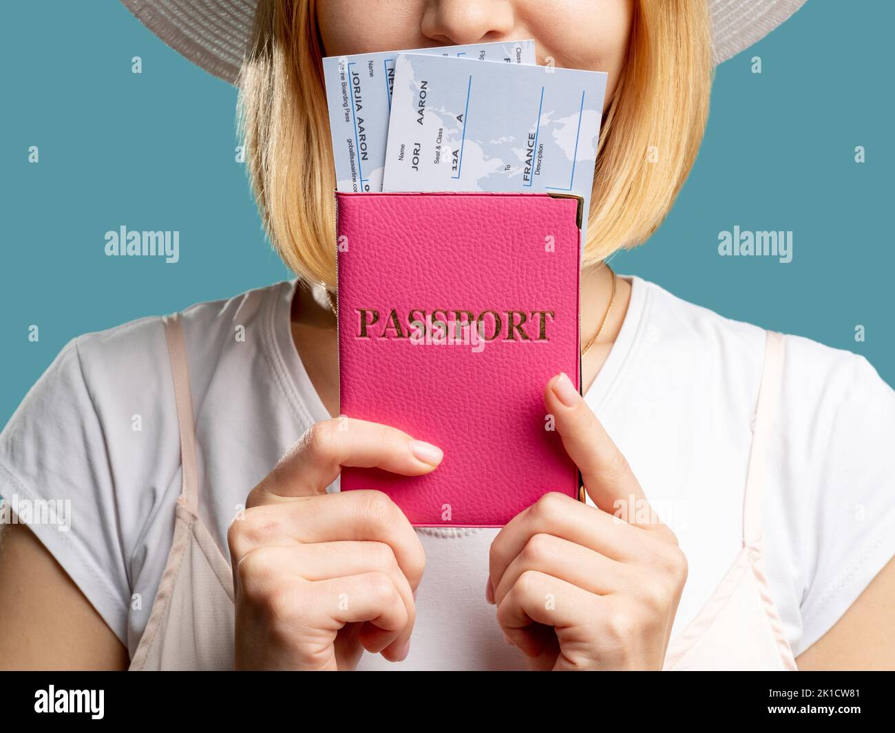 Summer trip. Passport control. Woman in white holding pink foreign id ...