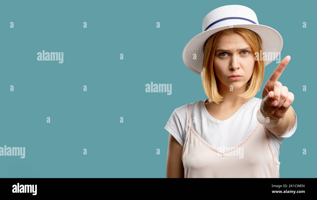 Warning gesture. Stop sign. Angry woman in white pointing finger to ...