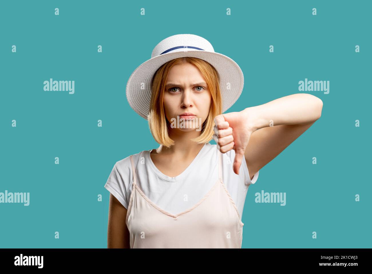 Dislike gesture. Disapproval sign. Sad woman in white summer outfit ...