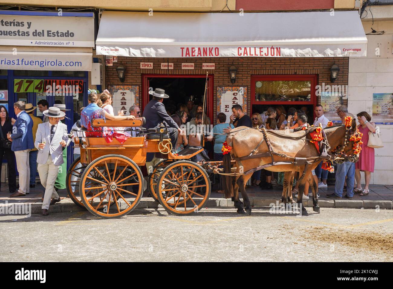 Traditional decorated horse carriage, in front of spanish bar, during ...