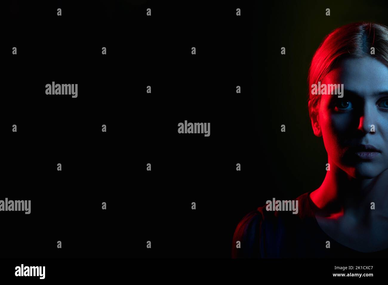Female silhouette portrait. Neon light. Scared woman in green red glow ...