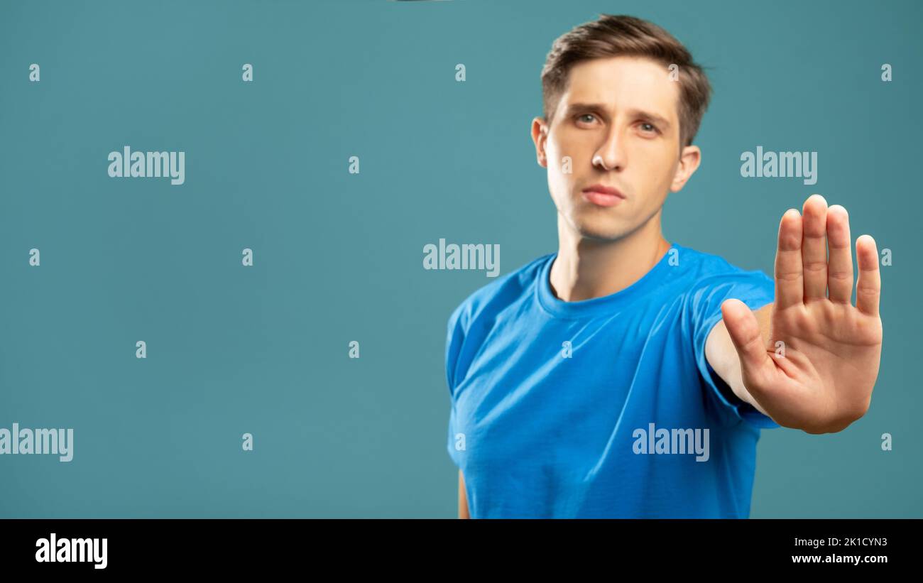 Stop sign. Forbidden way. Warning notice. Confident young man holding ...