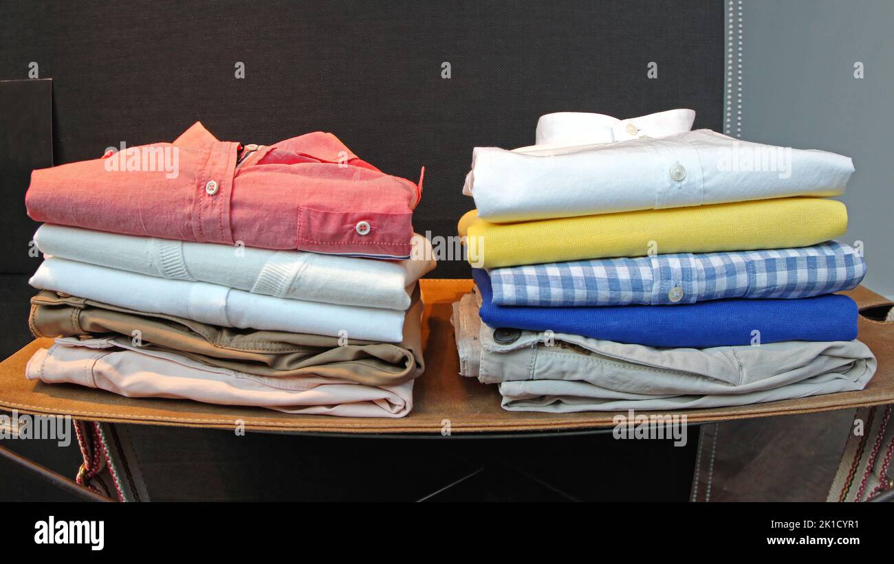 Two stacks of clean modern clothes folded at shelf Stock Photo - Alamy