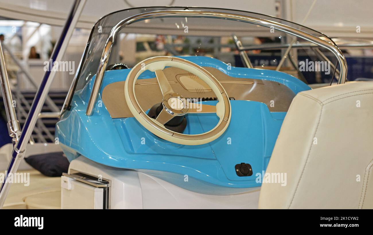 Retro style steering wheel at blue and beige boat cockpit Stock Photo ...