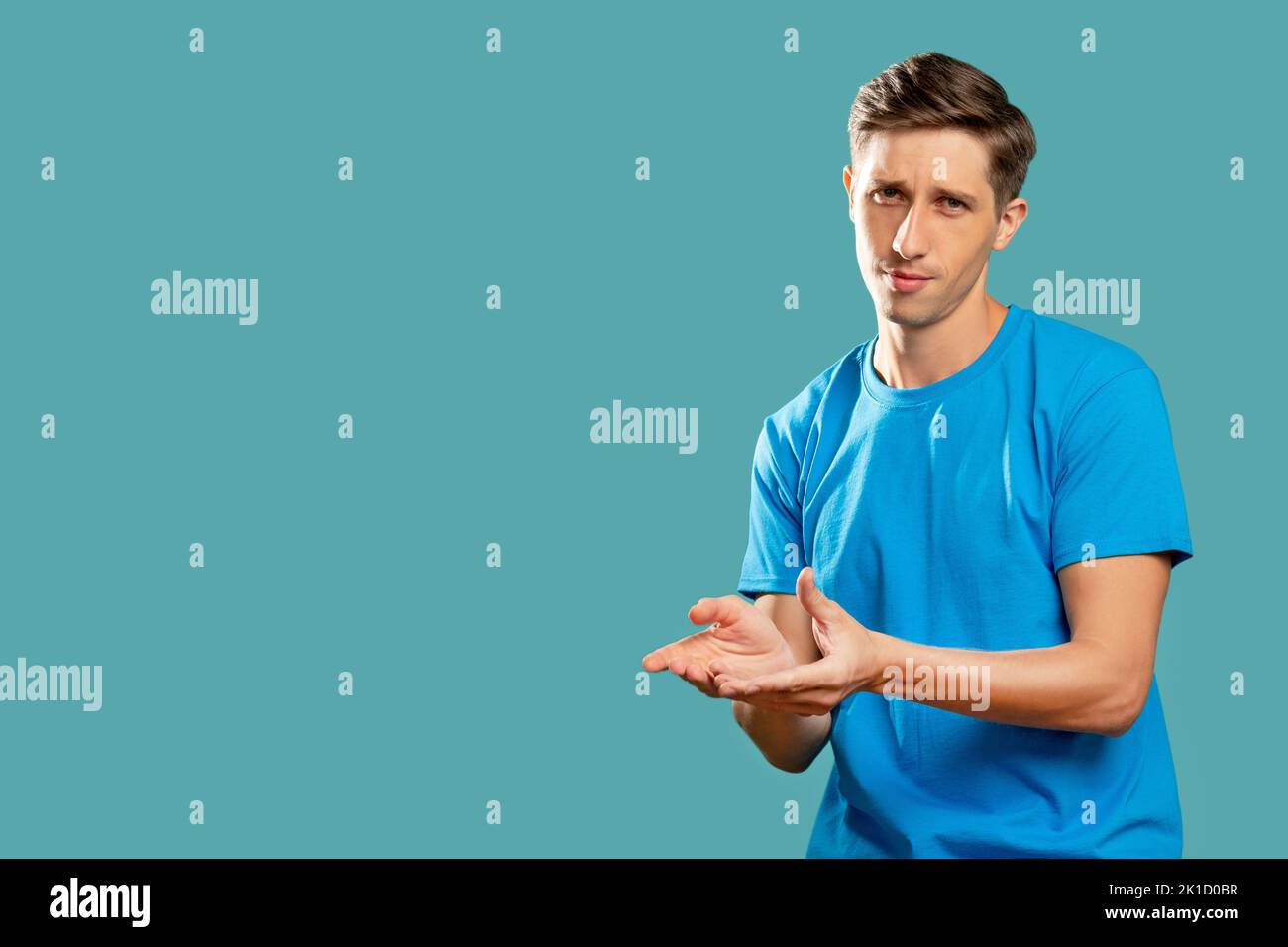 Doubtful man. Begging gesture. Invisible product. Young confused guy ...