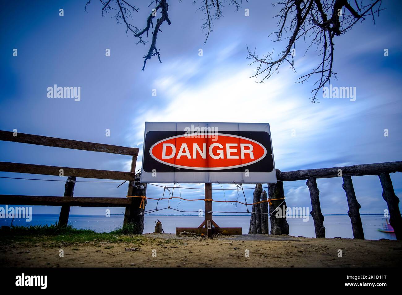 A big sign with a "Danger" warning text in cloudy sky background Stock ...