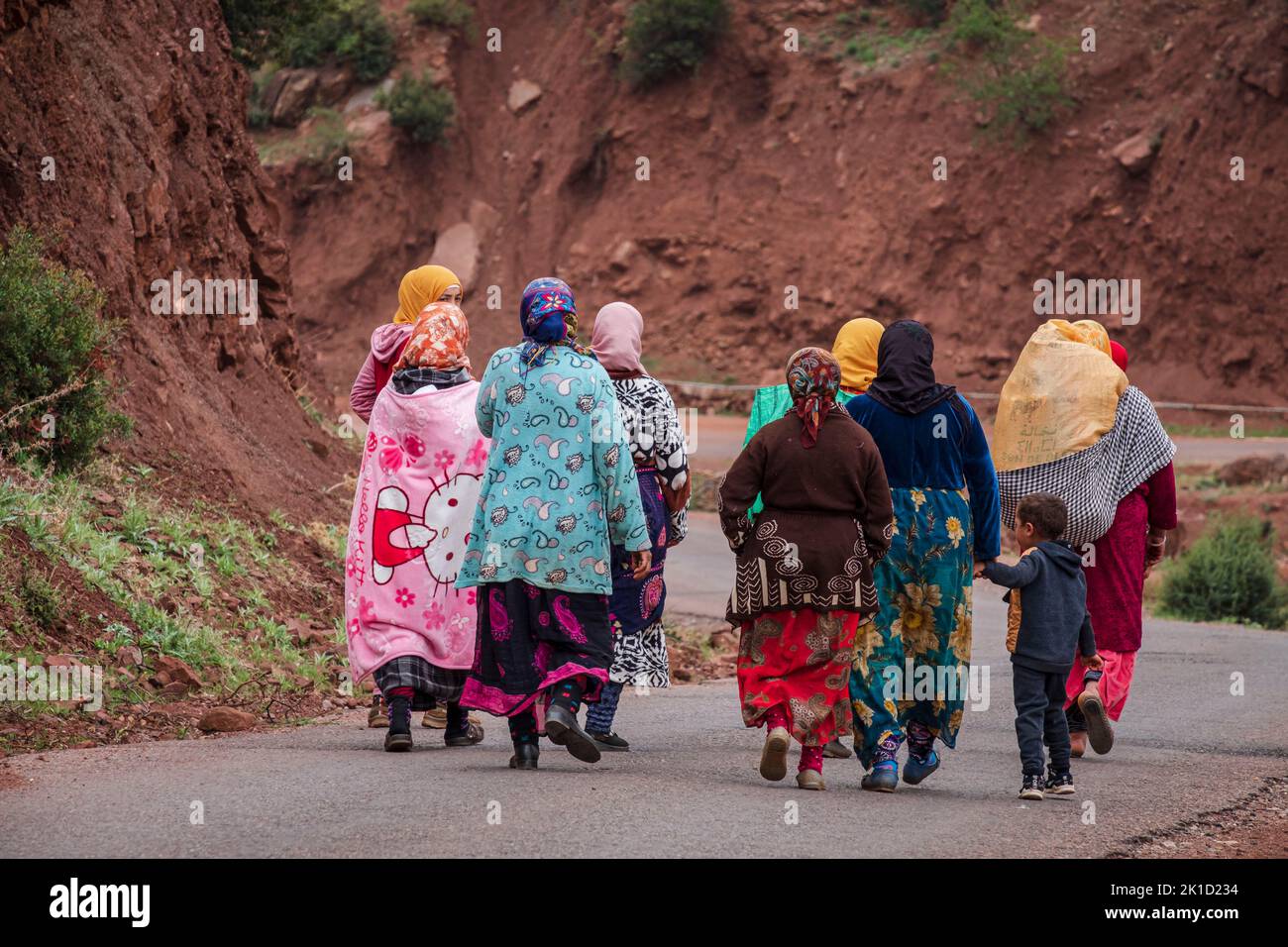 group of berber women going to work on a paved road, Ait Blal, azilal ...