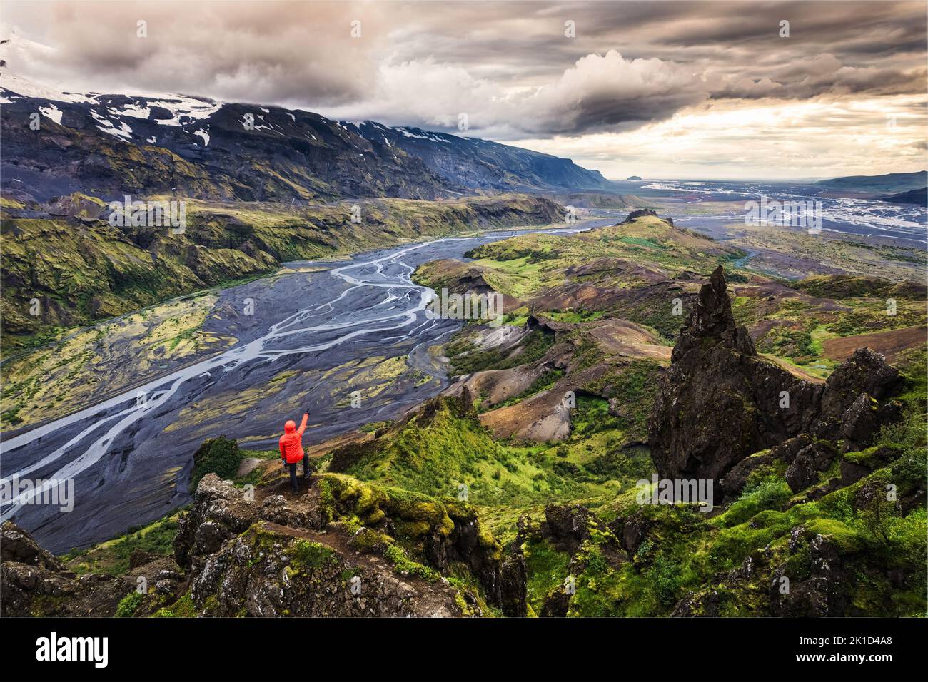 Scenery of Hiker man in red jacket standing on peak of Valahnukur ...
