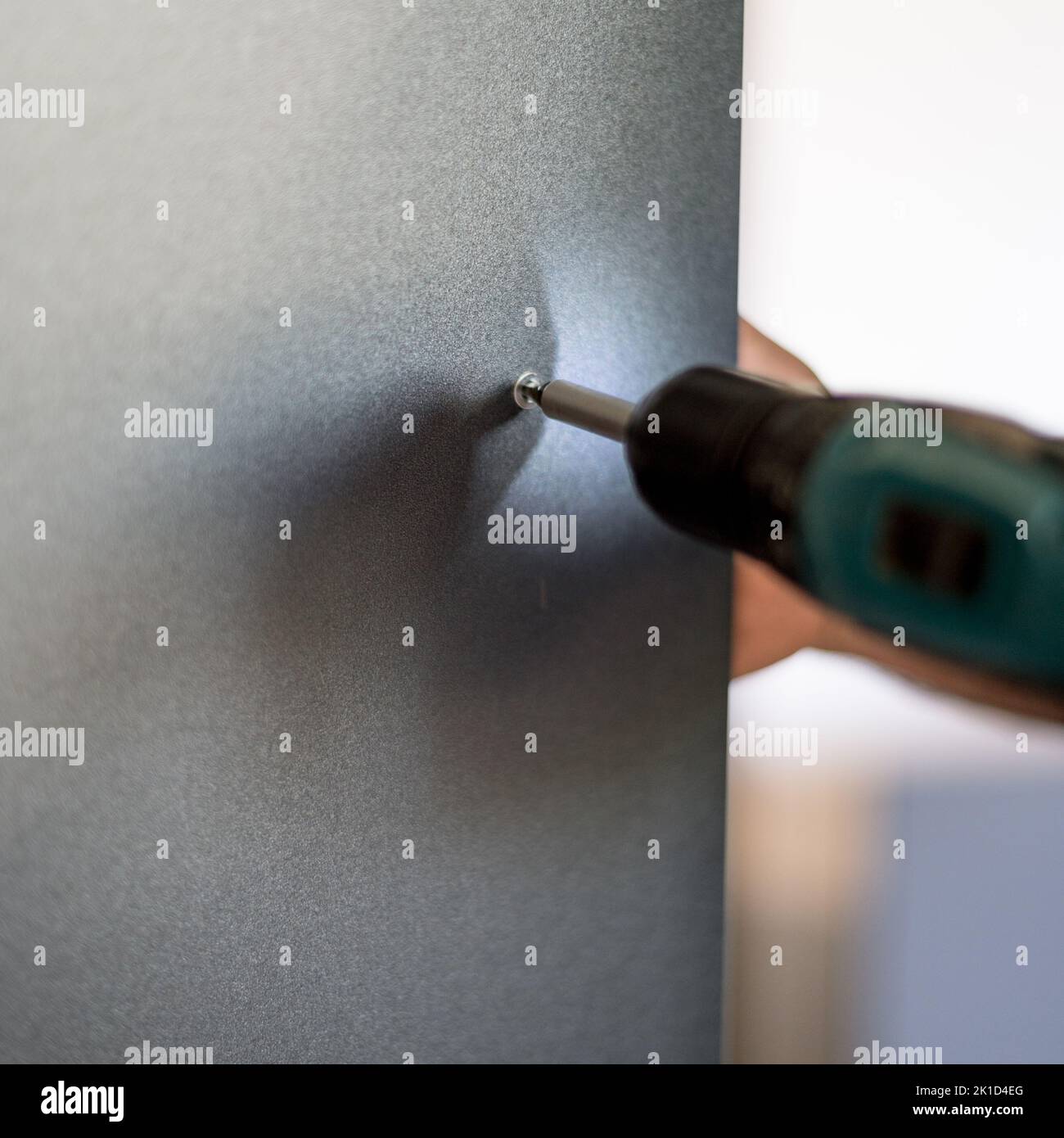 The process of screwing the screw, installing a sliding door wardrobe ...