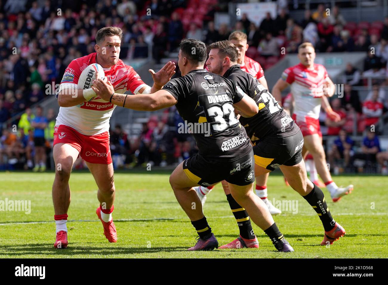 Louie McCarthy-Scarsbrook #15 of St Helens runs at Tyler Dupree #32 of ...