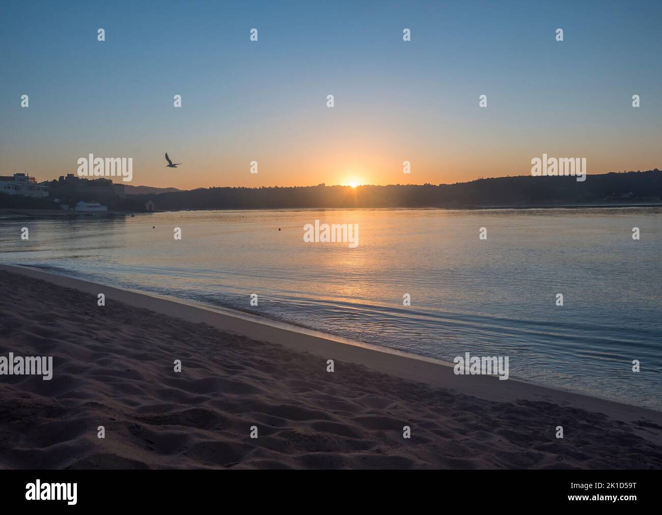 Orange sunrise at empty sand beach Praia da Franquia at Vila Nova de ...