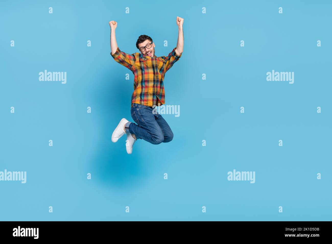 Full length photo of crazy lucky person raise fists triumph jumping ...