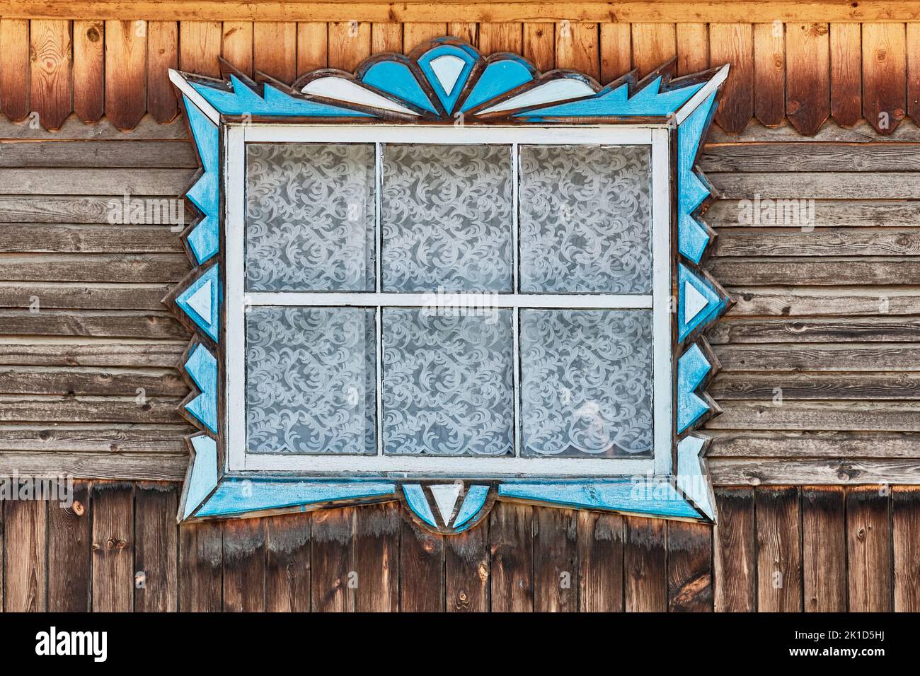 Old wooden window with carved architraves.Plank facade of veranda of ...