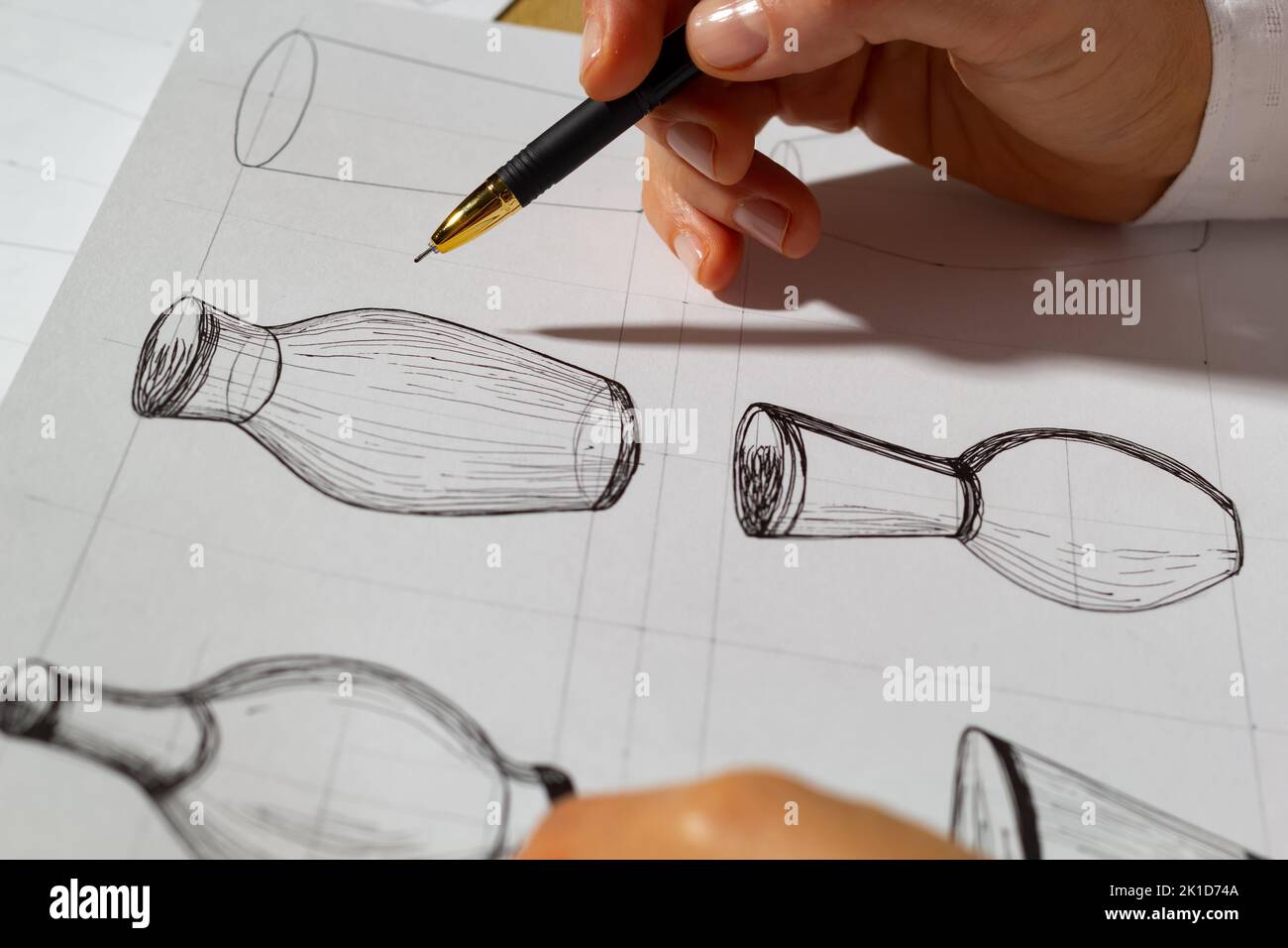 The designer draws sketches of kitchen utensils on paper. The artist ...