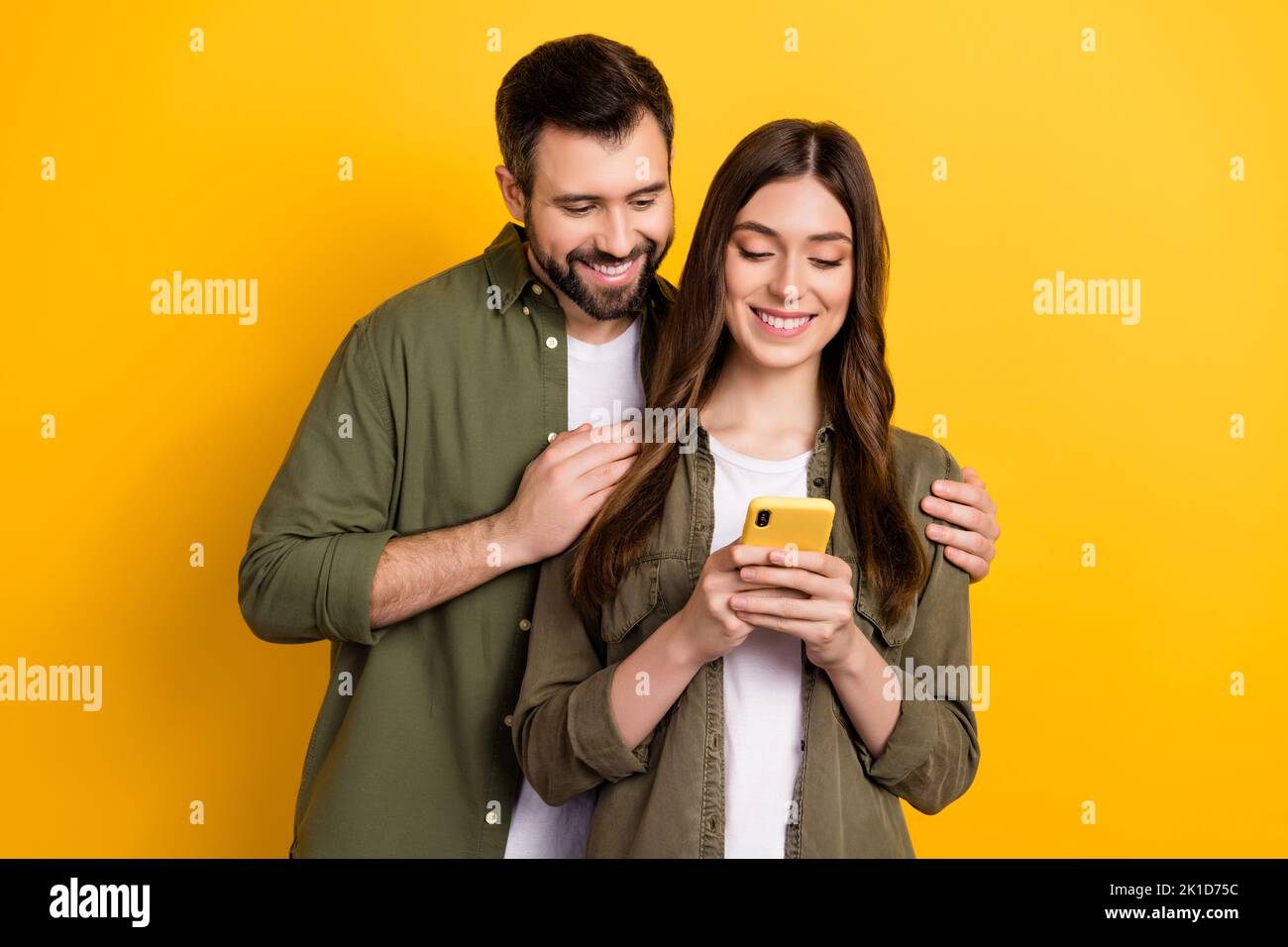 Photo of cheerful good mood couple surfing smartphone do online ...