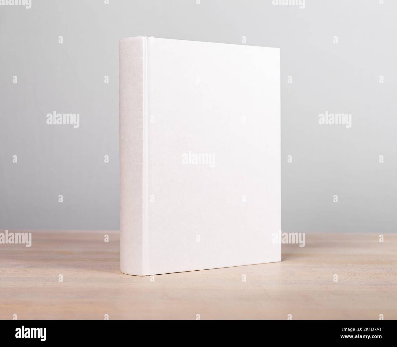 Book mockup standing at wooden table. Novel, encyclopedia, code ...
