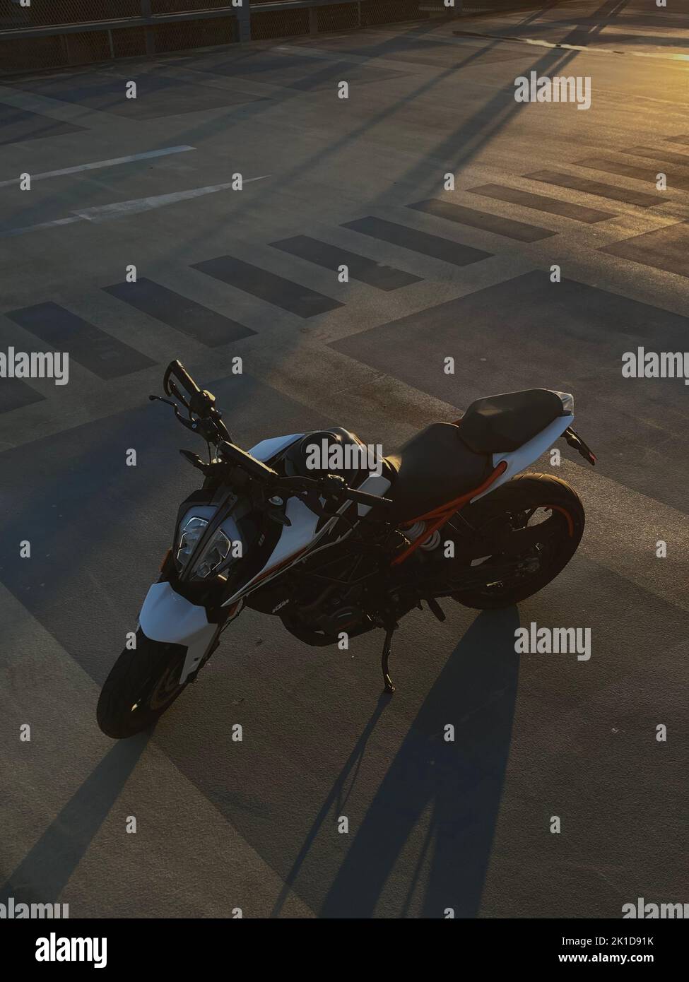 A vertical closeup shot of a KTM Duke 125 motorcycle at an outdoor ...