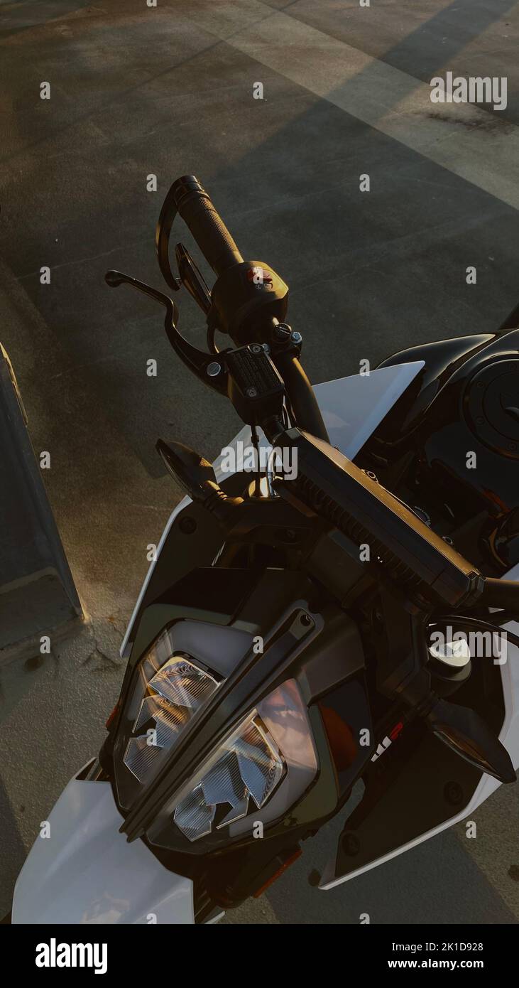 A vertical closeup of the front part of KTM Duke 125 motorcycle at an ...