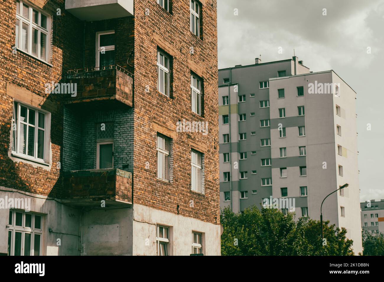 An old apartment building made of bricks close to a renovated block in ...