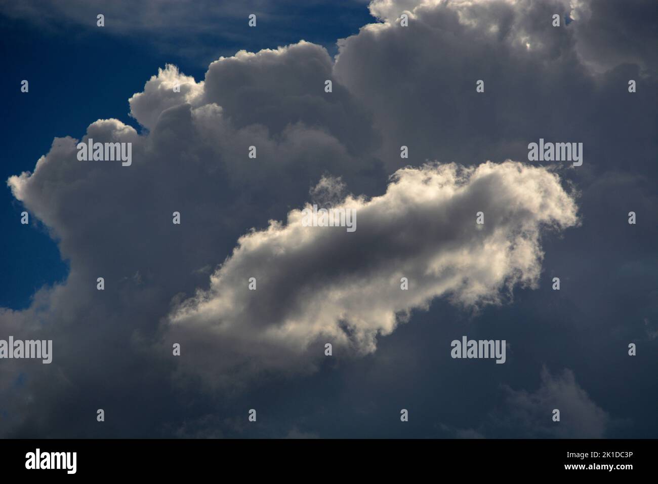 Cumulus clouds fill the sky over the American Southwest near Santa Fe ...