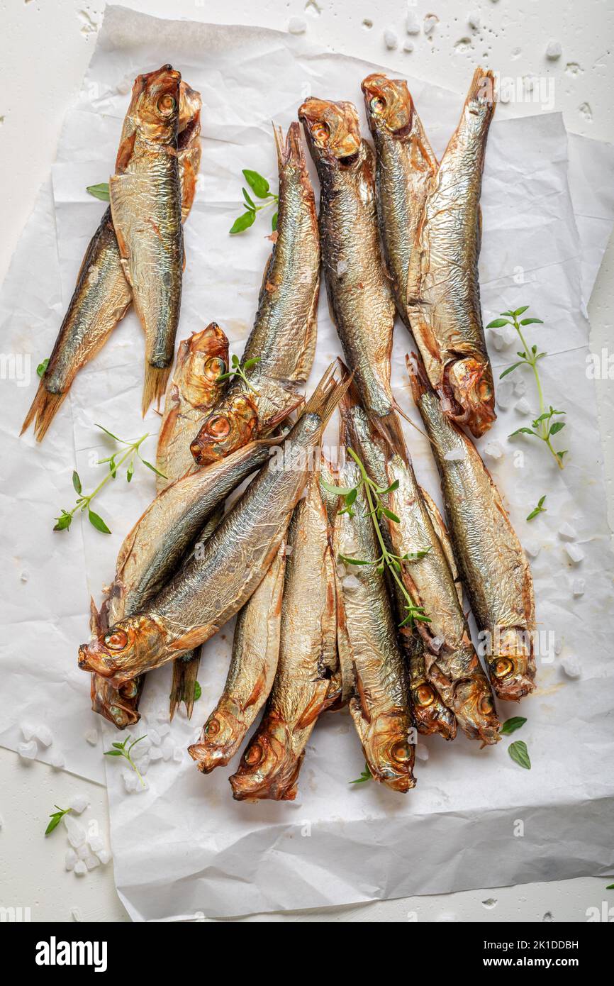 Fresh smoked sprats as appetizer by the sea. Smoked fish marinated with ...