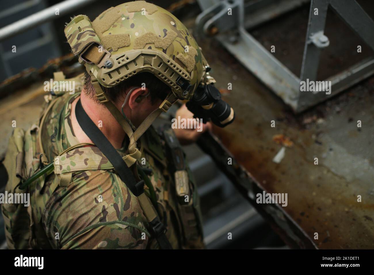 A U.S. Sailor assigned to a Navy SEAL Team, climbs down a hatch during ...