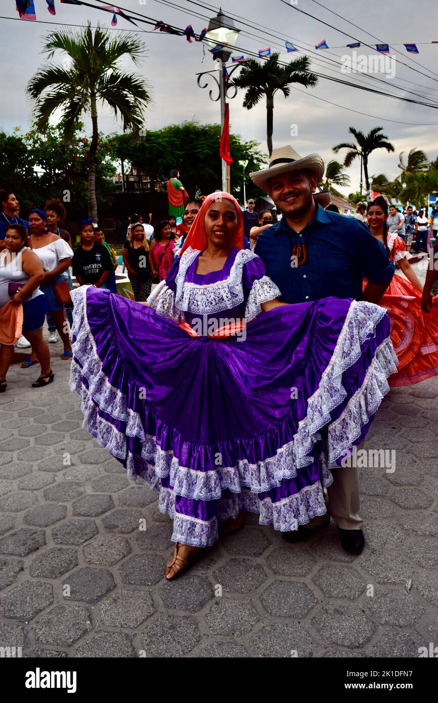 Traditionally dressed men and women parading down the streets in San ...