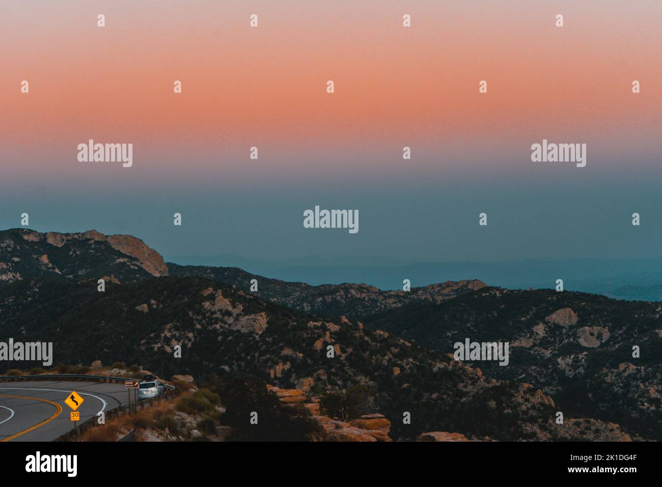 An aerial view of a country road and mountain landscape with long ...