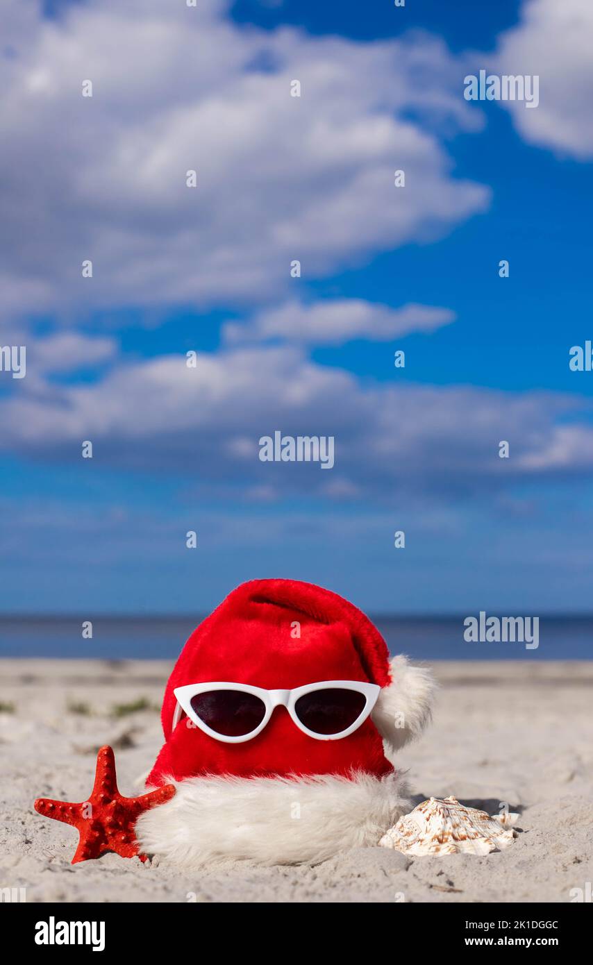 Christmas background Santa Claus hat on the beach with starfish and ...