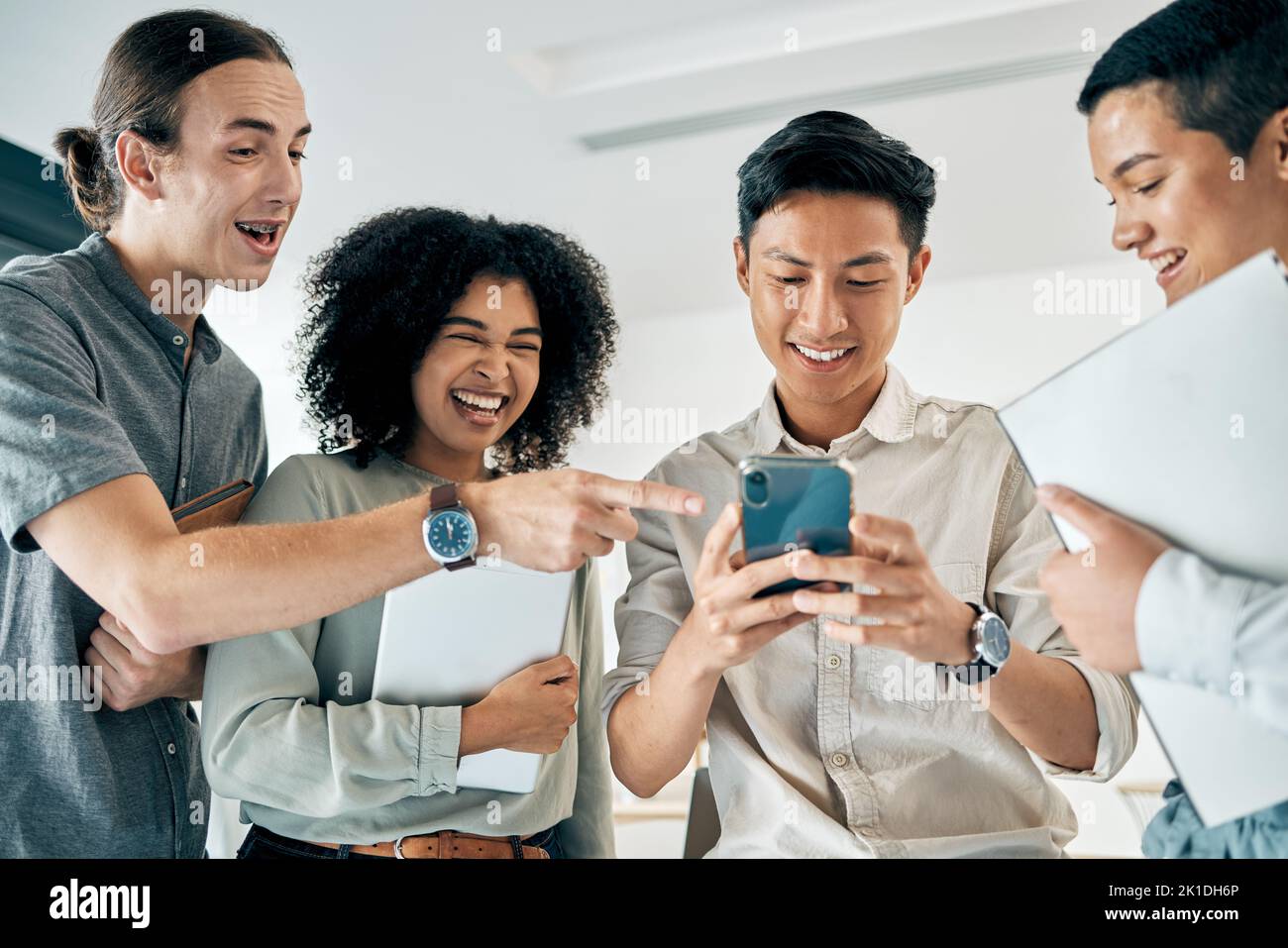Diversity, startup and a happy team of women and men on a phone, after ...