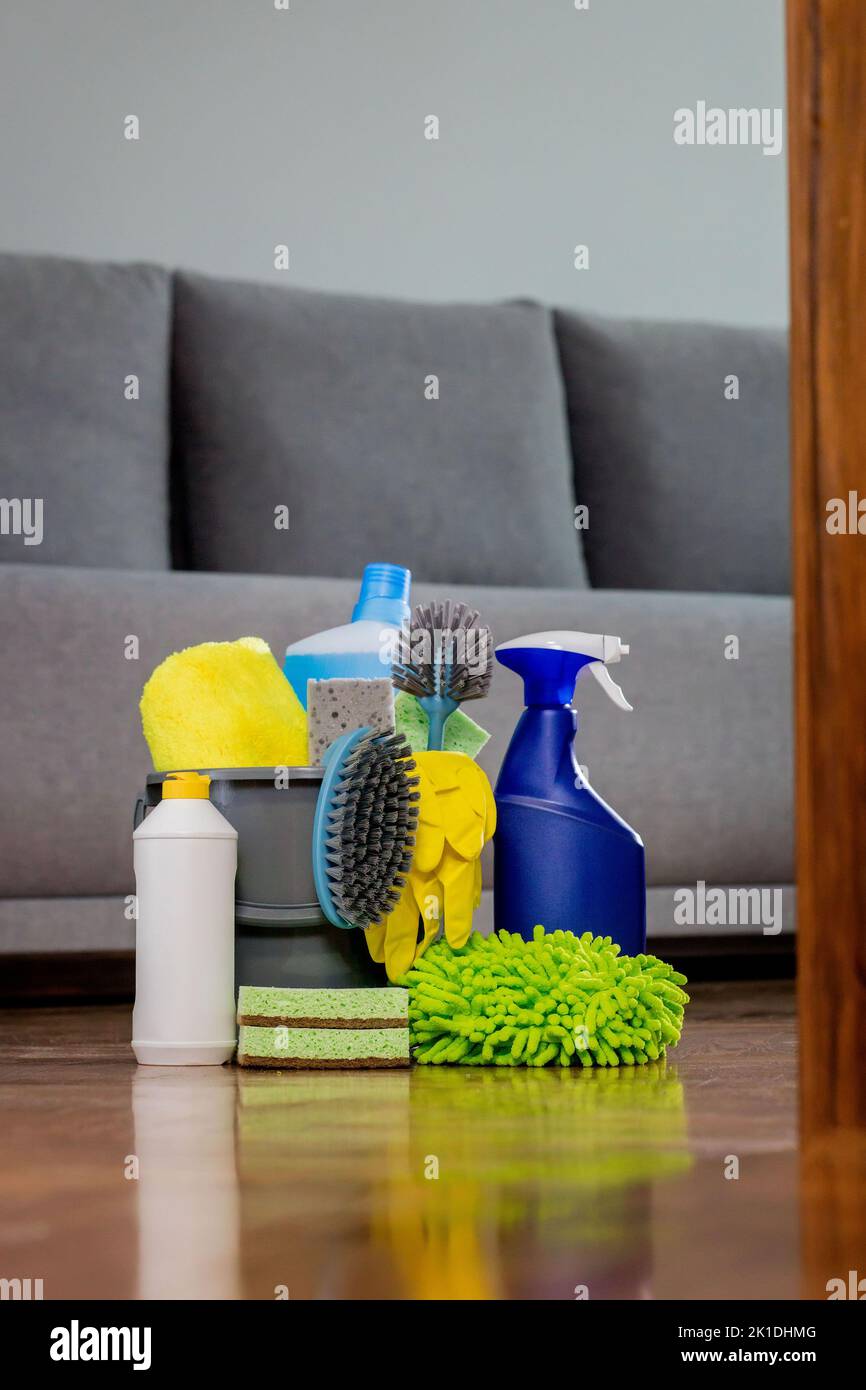 Household cleaning products and rags with reflection in the floor ...